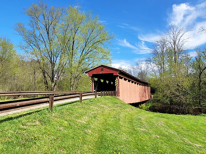Standing proud since 1887, the crimson-clad Sarvis Fork Covered Bridge welcomes travelers with the same rustic charm that greeted horse-drawn buggies over a century ago.
