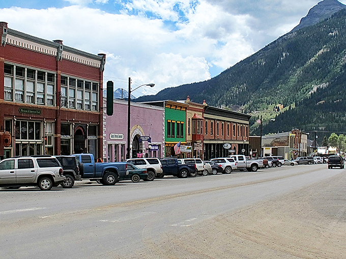 Greene Street's historic storefronts stand like colorful sentinels against the San Juan Mountains, a main drag that hasn't changed its tune in a century.