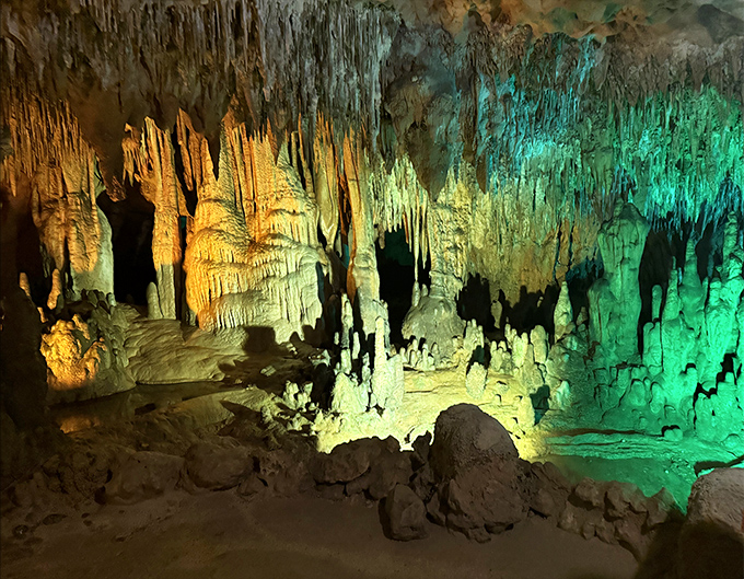 Underground wonderland: Stalactites and stalagmites create a mesmerizing light show, like nature's own cathedral built one mineral deposit at a time over millennia.