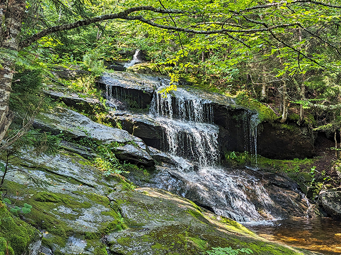 Nature's own watercolor masterpiece &ndash; Step Falls cascades over ancient granite while trees dressed in autumn finery provide the perfect backdrop.