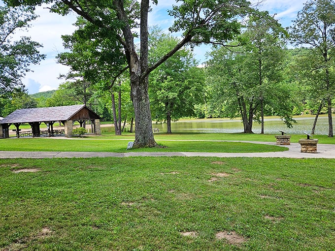 Picnic paradise meets lakeside serenity. This shaded haven at Shawnee State Park offers the perfect spot for family gatherings where nature provides the entertainment.