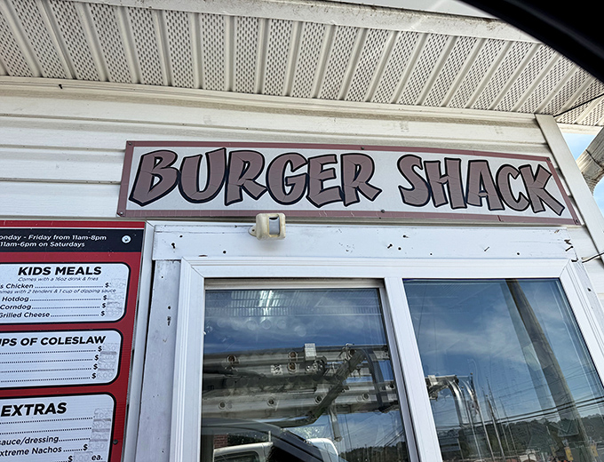 The simple red-and-white sign says it all – no fancy frills needed when the burgers speak volumes for themselves.