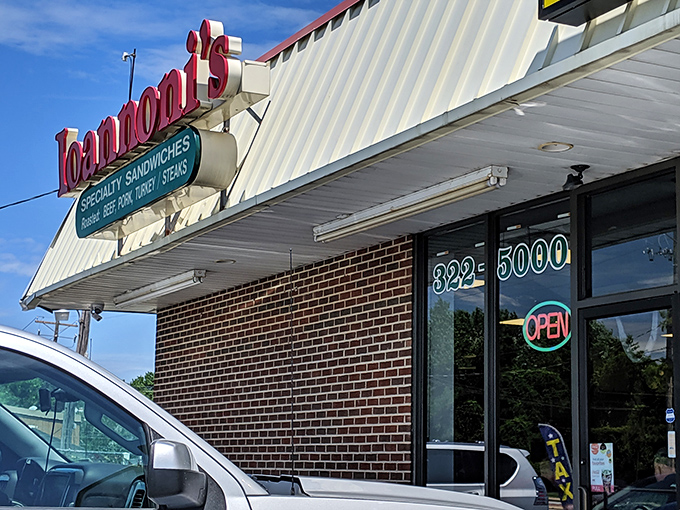 The iconic red Ioannoni's sign stands out like a culinary lighthouse, guiding hungry souls to sandwich salvation on even the bluest Delaware day.