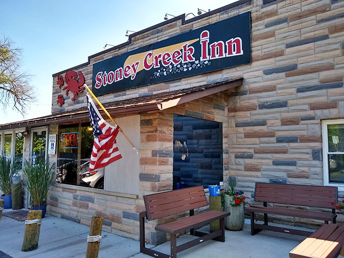 American flag waving proudly outside this unassuming seafood sanctuary – where locals know the real Maryland treasures await.