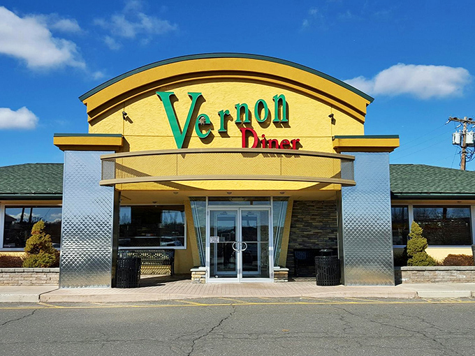 The golden facade of Vernon Diner gleams like a beacon of hope for hungry travelers. Classic Americana with a touch of modern flair.