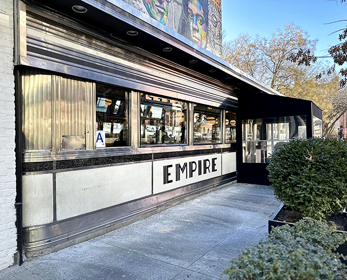 The gleaming Art Deco exterior of Empire Diner stands like a chrome time capsule in Chelsea, beckoning hungry New Yorkers with its bold, confident signage.
