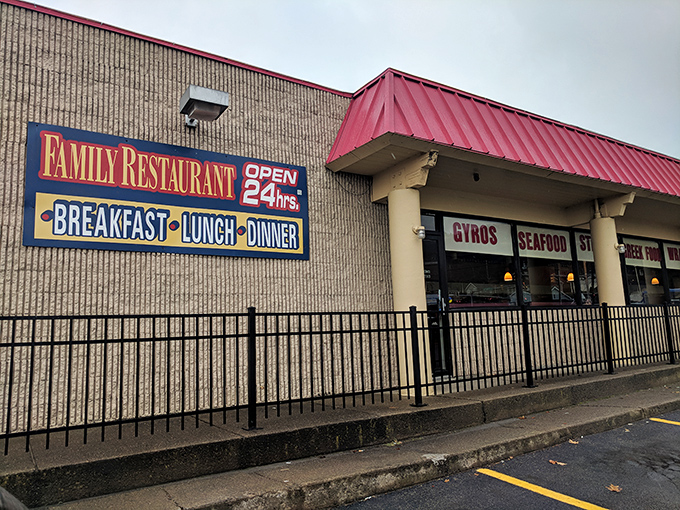 Beyond the wrought iron fence lies a temple of comfort food, where the "Open 24hrs" sign promises breakfast salvation regardless of what your watch says.