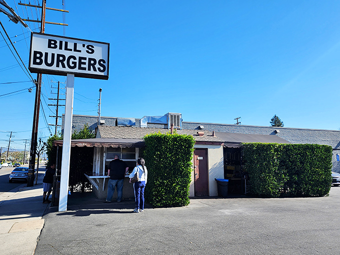 The unassuming exterior of Bill's Burgers stands like a time capsule against the Sherman Oaks sky, promising burger perfection without any fancy frills.