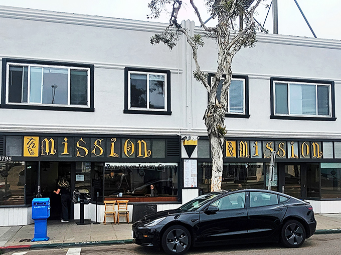 The distinctive golden signage of The Mission beckons breakfast lovers with its promise of "Breakfast-Lunch-Coffee" in Mission Beach.