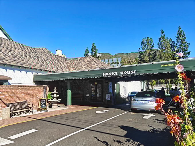 The unassuming exterior of The Smoke House belies the culinary treasures within. Hollywood history and sizzling steaks await behind these modest doors.
