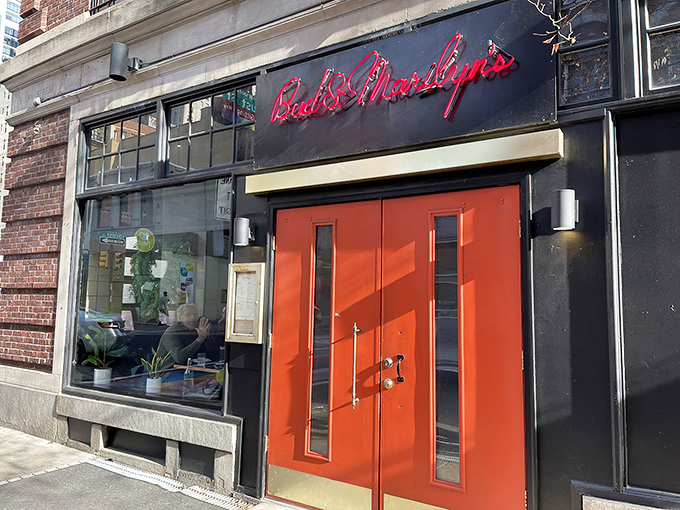 That iconic orange door against the black exterior is like a beacon for hungry souls wandering Philadelphia's Midtown Village. The neon sign promises good things await.
