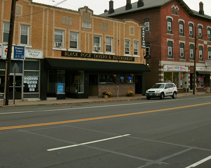 The Black Rock Tavern stands as Main Street's cornerstone, offering comfort food and local brews in a setting that screams "Cheers, but with better architecture."