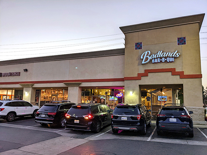 The unassuming strip mall exterior of Badlands BBQ proves once again that the best barbecue joints often hide in plain sight, like culinary speakeasies for the carnivorous soul.