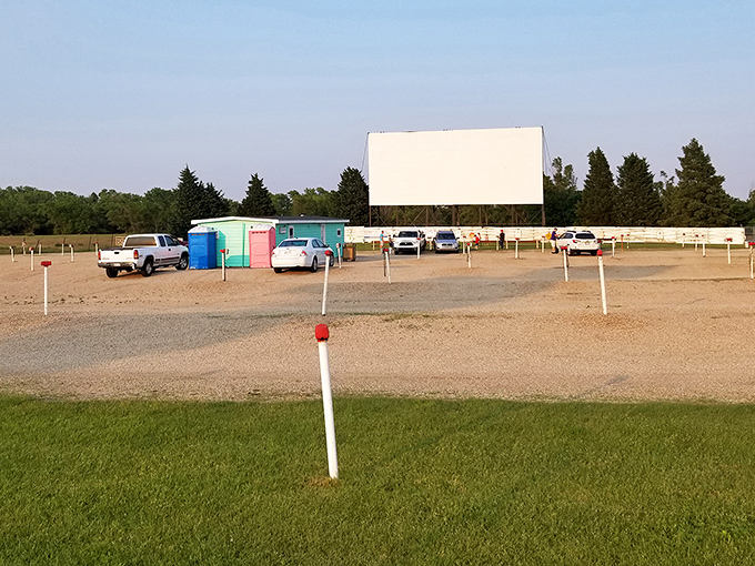 The classic white screen of Kanopolis Drive-In stands tall against the Kansas sky, a beacon for movie lovers seeking nostalgic entertainment under the stars.
