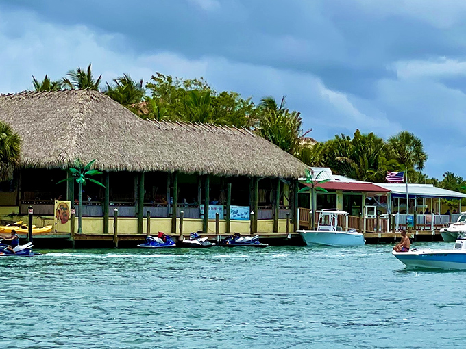 Paradise found! Pop's iconic thatched roof tiki hut beckons from the Intracoastal Waterway, promising cold drinks and fresh seafood with a side of Florida magic.