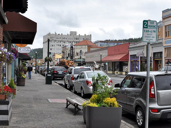 Downtown Astoria's historic streets blend old-world charm with modern vitality, where hanging flower baskets and colorful storefronts create a scene worthy of a postcard.