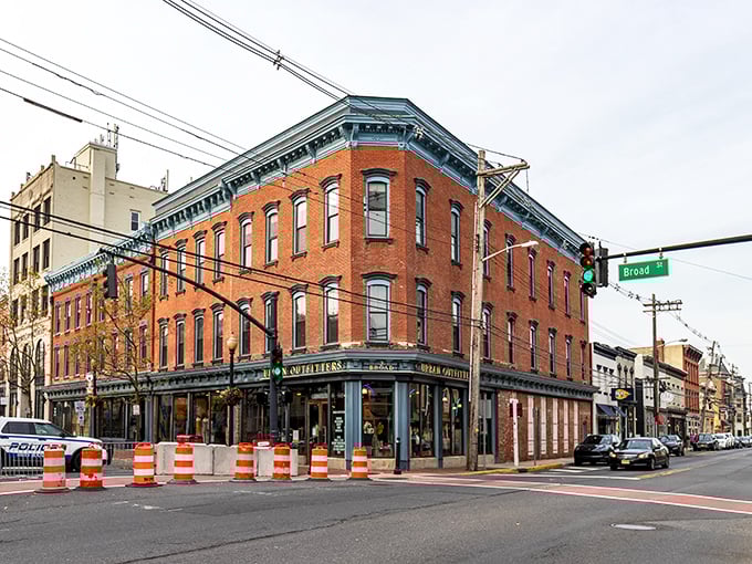 Historic brick buildings with distinctive blue trim line Broad Street, where Red Bank's architectural character shines through even on a cloudy day.