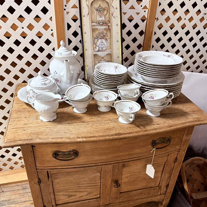 Grandma's china has nothing on this elegant antique dishware set, perfectly displayed atop a sturdy oak washstand with original hardware.
