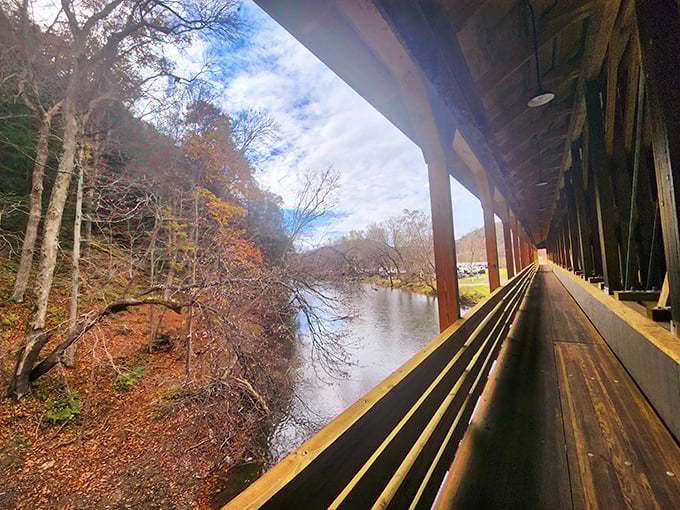 Walking through a covered bridge in autumn is like strolling through a tunnel where every step reveals a new watercolor masterpiece.