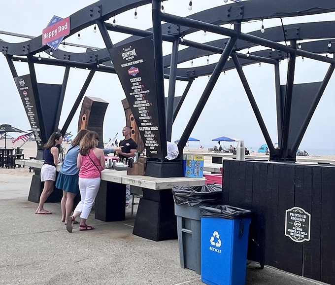 The outdoor bar area invites beachgoers to pause their sun-soaking for a refreshing drink and a bite with an unbeatable ocean view.