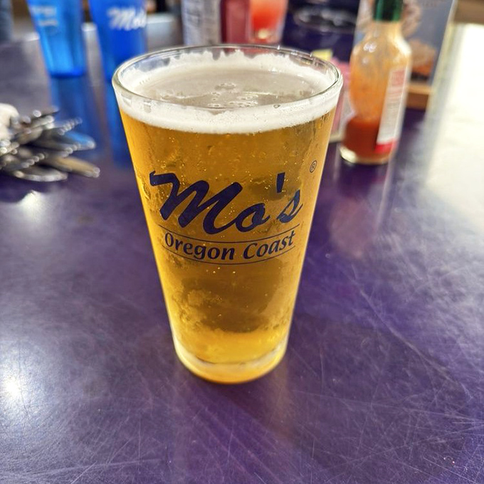 A cold beer in a Mo's glass&mdash;because sometimes the perfect chaser for ocean flavors is simple, cold, and golden.