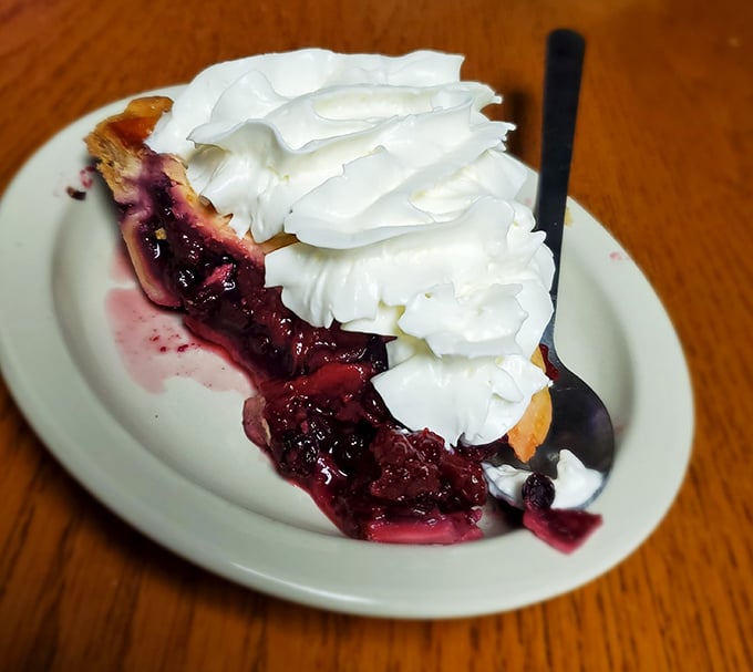 Blackberry pie crowned with whipped cream&mdash;the kind of dessert that makes you contemplate ordering a second slice immediately.