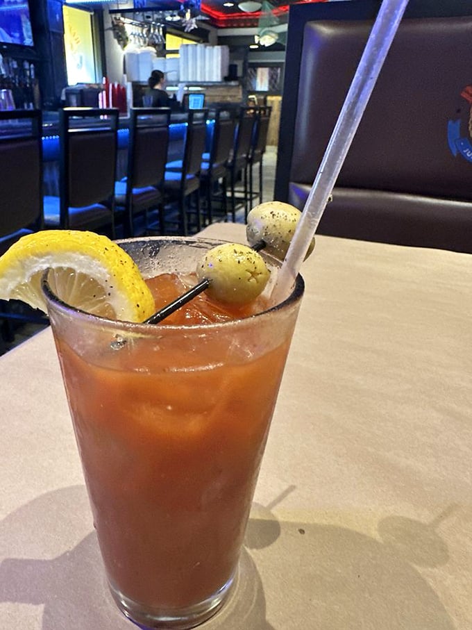 A Bloody Mary garnished with olives and lemon &ndash; the perfect liquid companion to a seafood feast, offering a spicy counterpoint to all that buttery goodness.