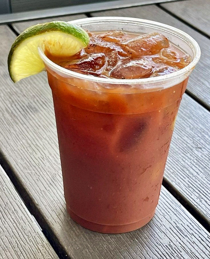A Bloody Mary that's practically a meal, garnished with lime and served in a plastic cup because fancy glassware would just get in the way of enjoyment.