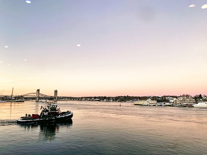 Working tugboats navigate the Piscataqua at sunset, proving Portsmouth remains a genuine maritime community, not just a pretty face.