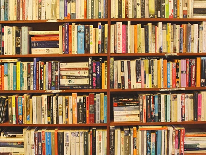 A bibliophile's dream where dog-eared paperbacks await their next adventure. Books stacked higher than your "to read" pile at home.