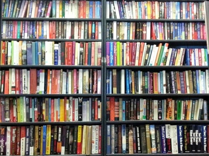 A bibliophile's dream wall—thousands of stories waiting to be rediscovered, from beach reads to classics that never go out of style.