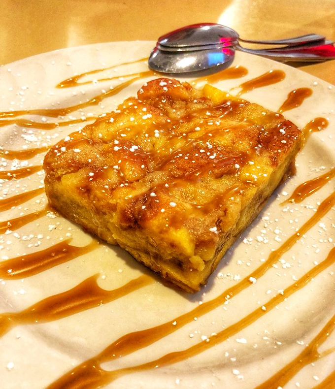 Bread pudding drizzled with caramel sauce and powdered sugar&mdash;the kind of dessert that makes you reconsider your life choices.