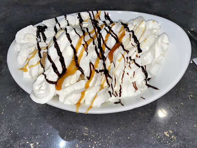 This dessert doesn't just satisfy your sweet tooth—it stages a full-scale invasion, with whipped cream mountains drizzled in chocolate and caramel battle armor.