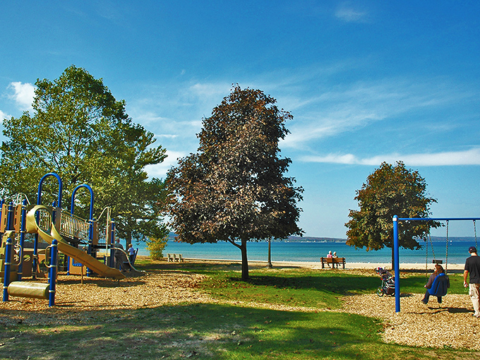 Where childhood meets shoreline: a playground with the best backdrop in Michigan&mdash;Grand Traverse Bay's shimmering waters just steps away.
