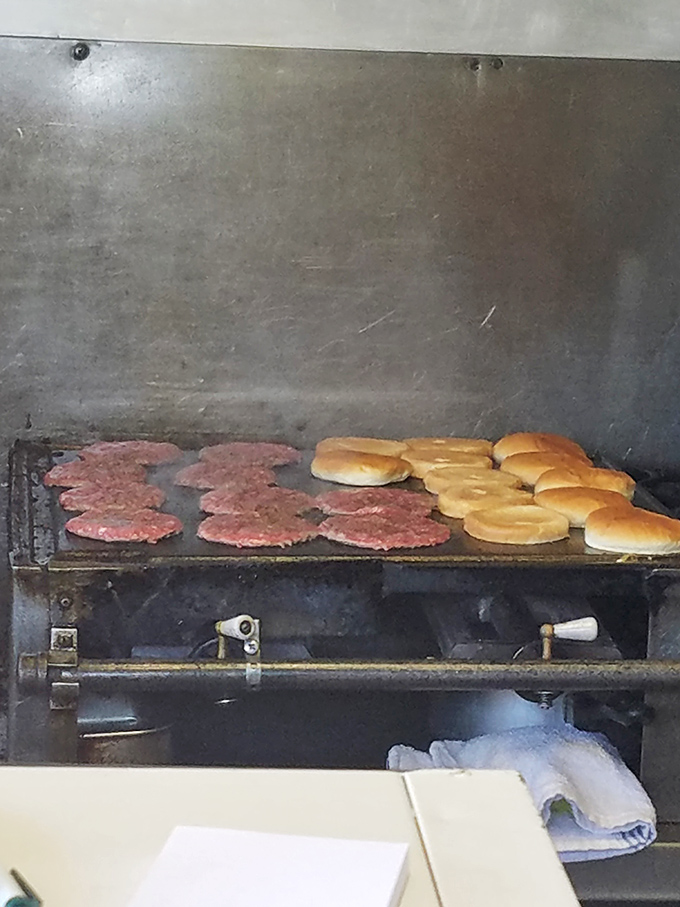 Burger patties and buns sharing grill space like old friends. This behind-the-scenes glimpse reveals the secret to those perfect crispy edges.