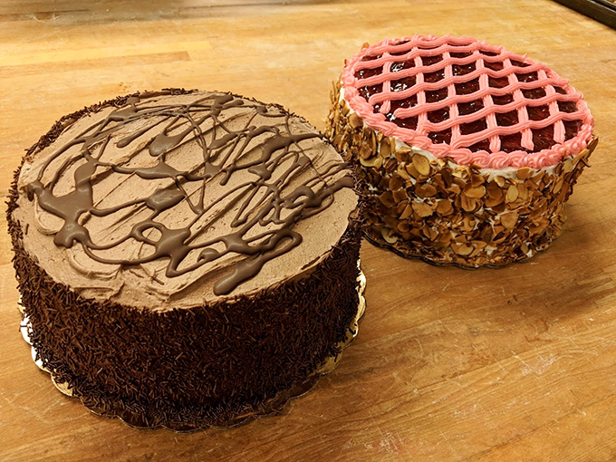Two cakes that prove frosting is an art form&mdash;one chocolate masterpiece, one pink lattice dream rimmed with toasted almonds.