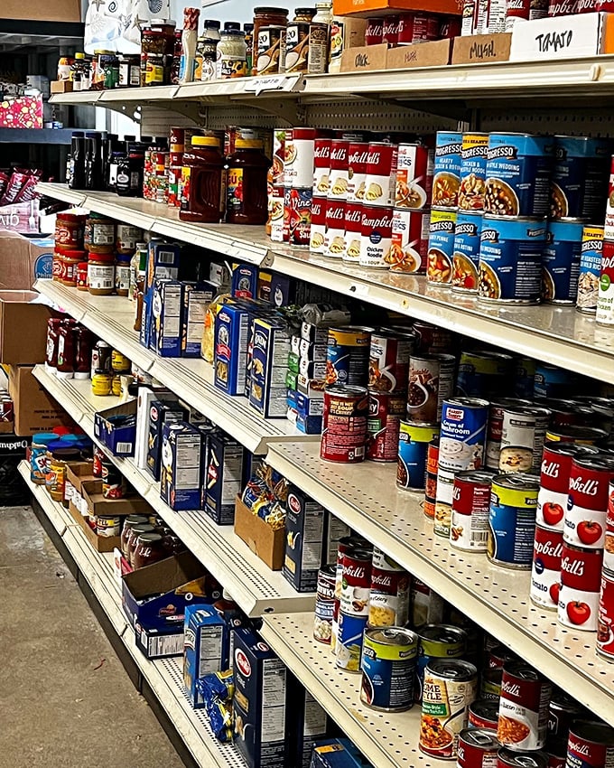 The food pantry section&mdash;where shopping fills your cabinets while helping your neighbors. These shelves stock both sustenance and community support.