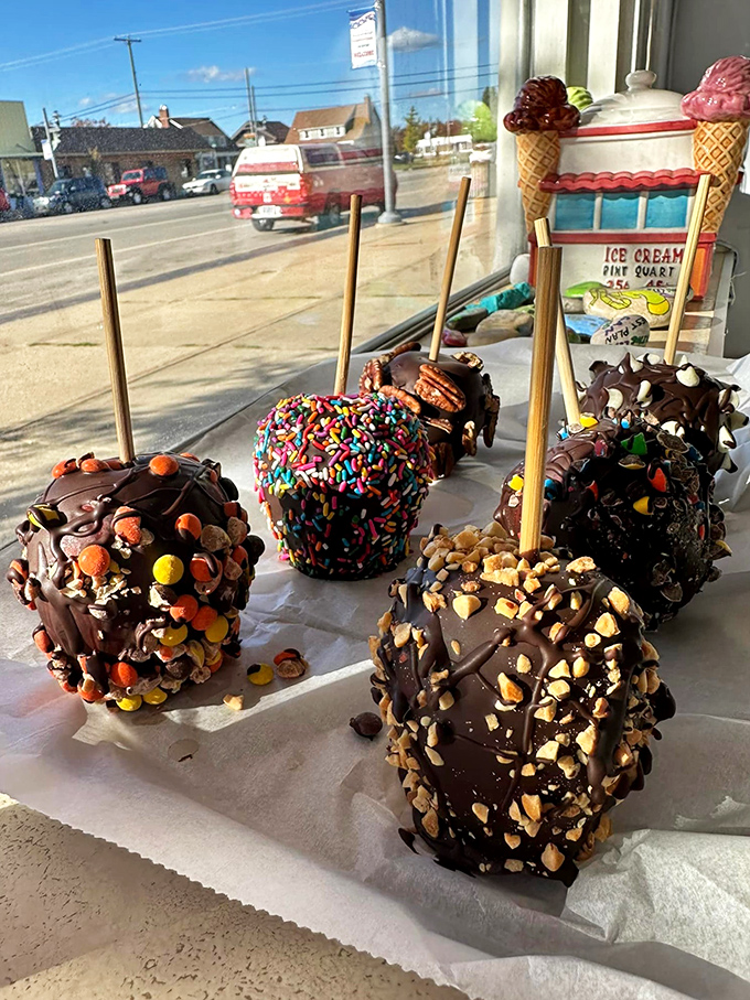 Chocolate-covered caramel apples on sticks, proving that some childhood traditions deserve permanent adult status in your life.