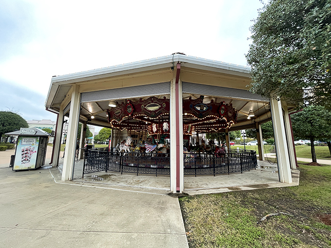 This carousel waits patiently to spin grandkids into giggling tornadoes while you catch your breath on nearby benches.