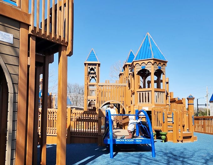 Castle Park's wooden towers and blue surfaces create a playground kingdom where imagination reigns supreme&mdash;no screens or batteries required. 
