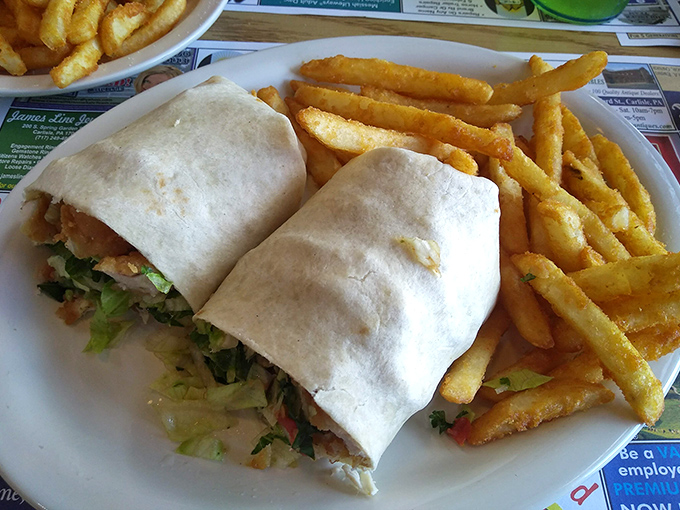 This wrap means business &ndash; stuffed with crispy chicken and fresh veggies, flanked by golden fries that are calling your name.