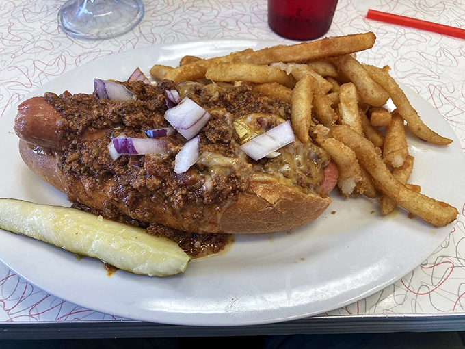 The chili dog arrives like a savory sundae&mdash;topped with meat sauce, onions, and enough napkins to suggest you'll need them for the delicious mess ahead.