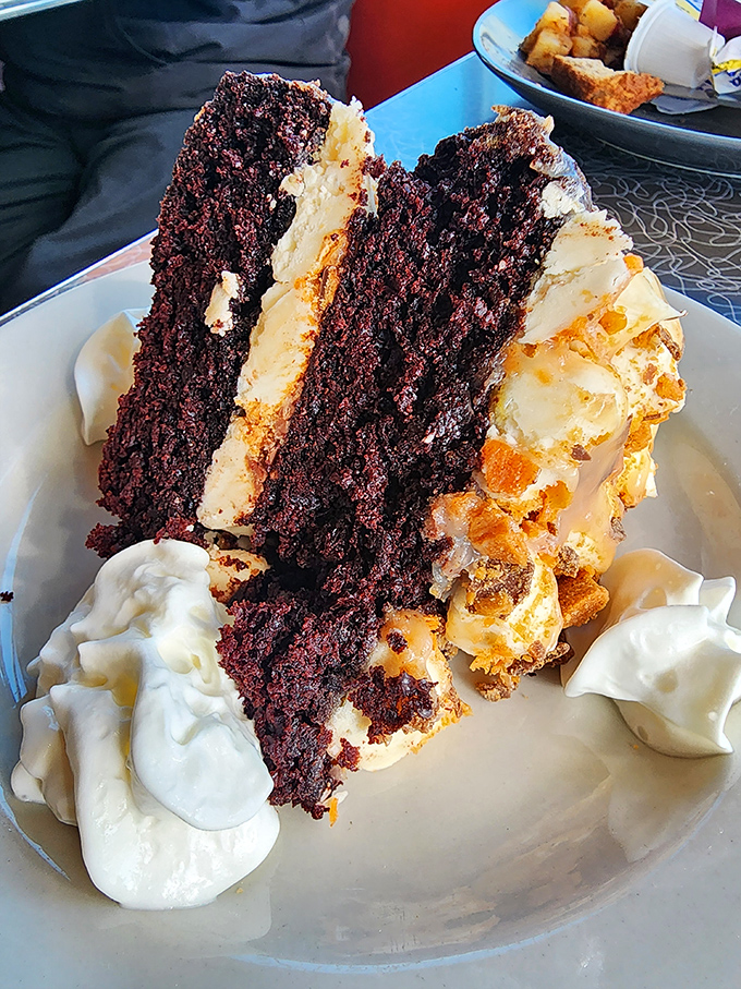A slice of chocolate cake so decadent it should come with a warning label. That cream cheese frosting isn't playing fair with your willpower.