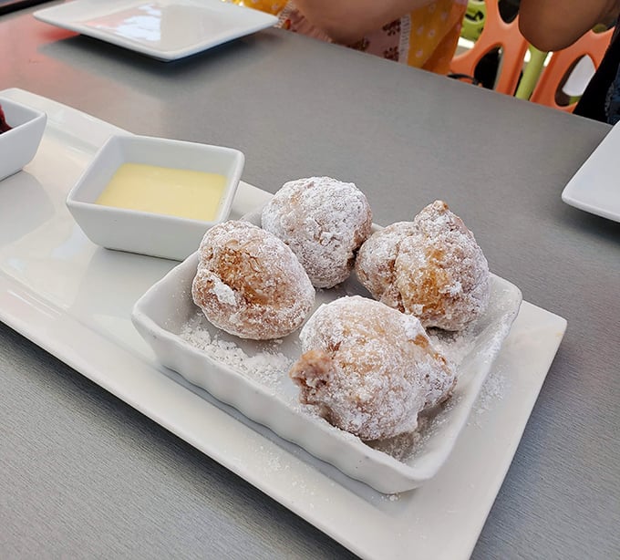 Beignets dusted with powdered sugar like fresh Denver snowfall. These pillowy delights might just make you forget you're not in New Orleans.