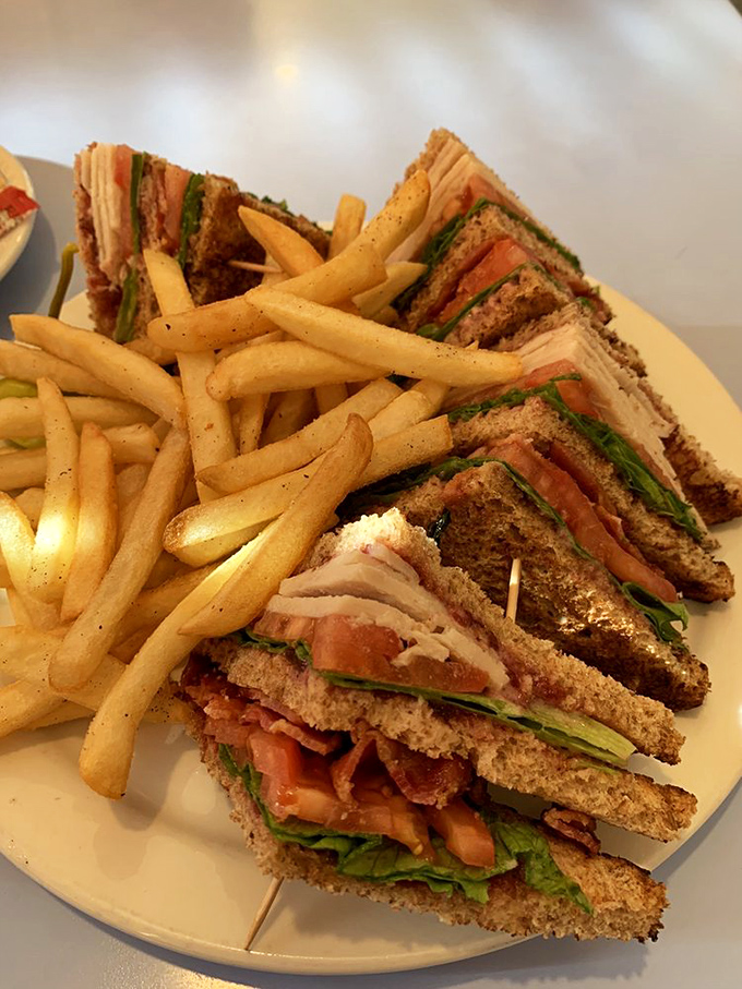 The club sandwich&mdash;that three-story architectural marvel of bread, meat, and vegetables that requires both hands and absolutely zero shame.