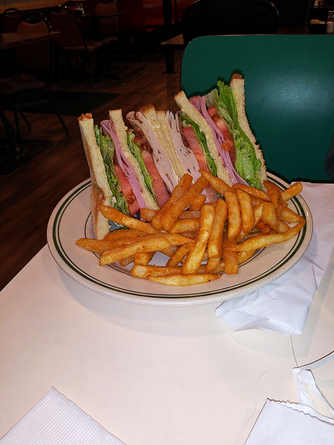 The club sandwich – three layers of proof that sometimes the classics endure because they're simply unbeatable, especially with those crispy fries.