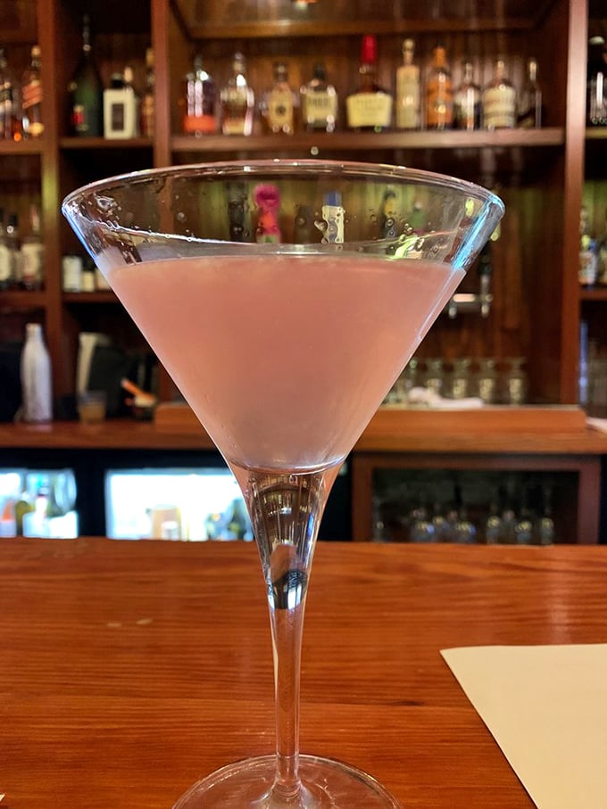 A martini glass filled with possibility—this pink concoction isn't just a drink, it's the beginning of a very good decision.