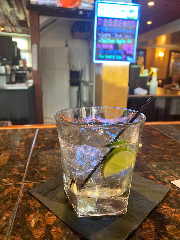 A perfectly clear cocktail with lime that whispers "civilization continues" amid the chaos of everyday life. Simple, elegant, and exactly what you need right now.