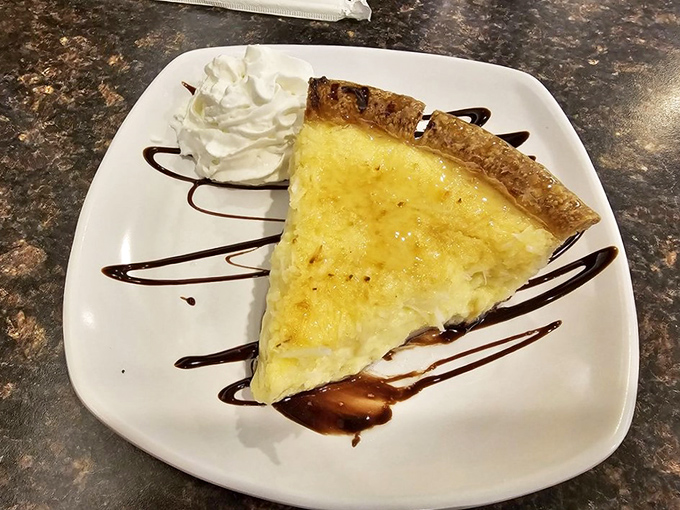 Coconut custard pie with artistic chocolate drizzle &ndash; the kind of dessert that makes you consider having pie for breakfast. Who's judging?