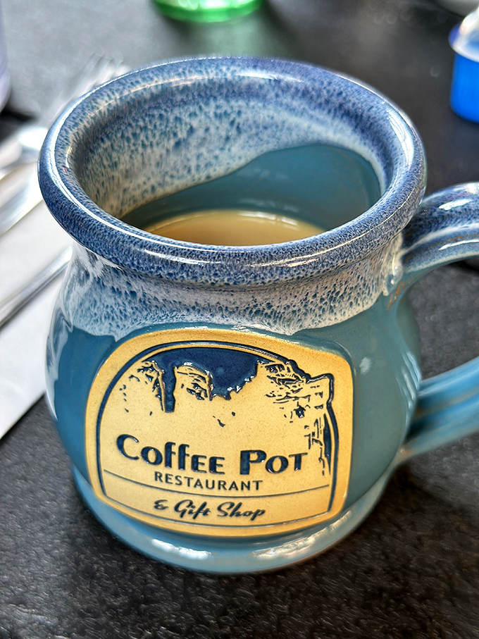 Coffee served in charming pottery mugs with the restaurant's logo&mdash;because presentation matters, even for morning caffeine.